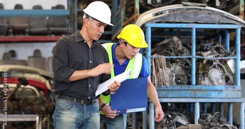 Old Machine auto parts in warehouses. Hispanic manager and asian man ...