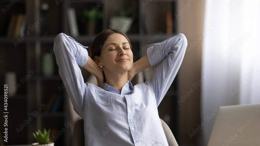 Putting workday on pause. Peaceful young woman relax by desk take break ...