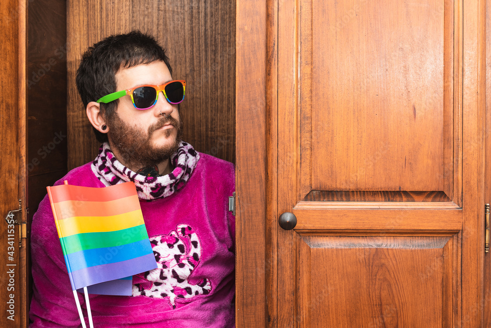 Homosexual man with nose piercings and sunglasses sitting inside the ...
