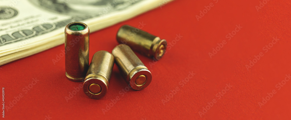 Desk with money and bullet for gun, criminal and corruption banner with ...