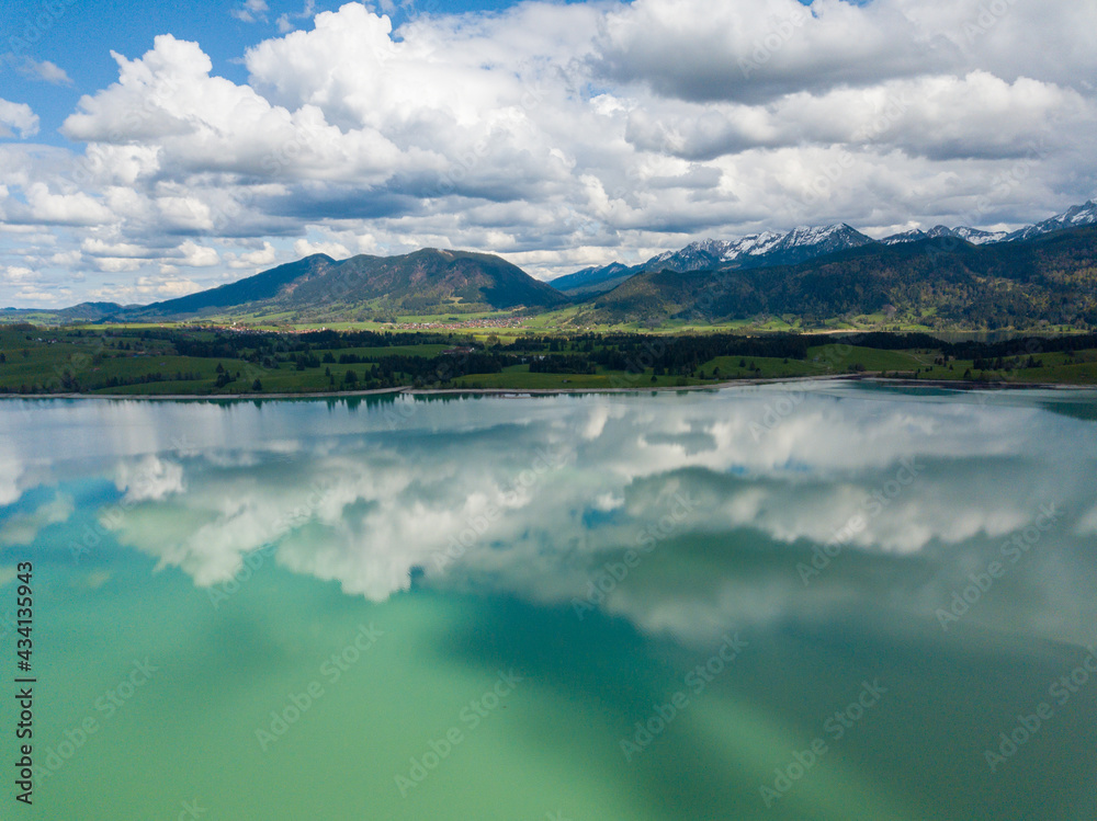 Forggensee Allgäu from above - Aerial view with mirroring clouds on a ...