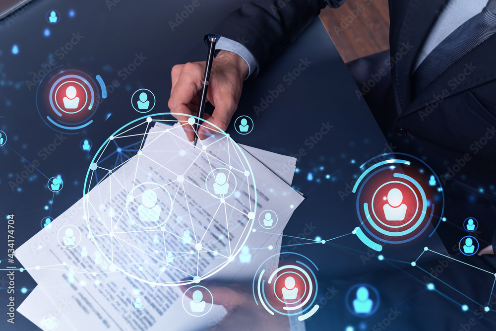 A potential employee in formal suit signing the contract to boost his ...