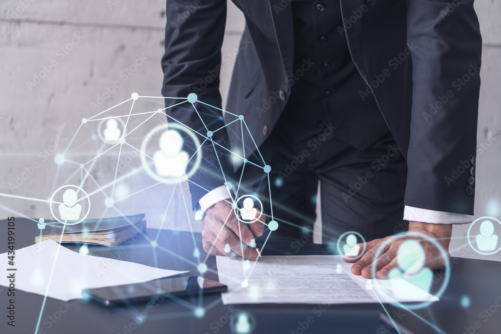 A potential employee in formal suit signing the contract to boost his ...