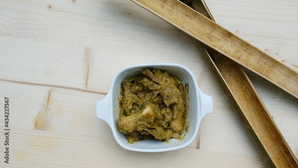A footage of "lemang" serve with chicken "rendang". Lemang is rice cook ...