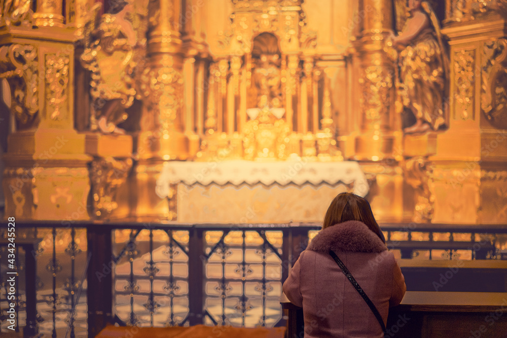 A woman in a temple prays to God. Woman praying in front of altar ...