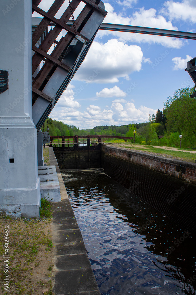 Old navigable river sluice. 20th century architecture with wooden ...