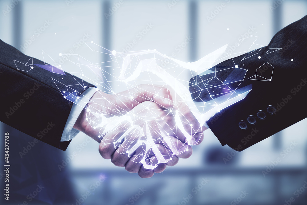 Double exposure of hand shake drawing hologram and handshake of two men ...