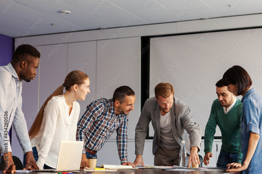 Group of six diverse business people led by middle aged manager bending ...