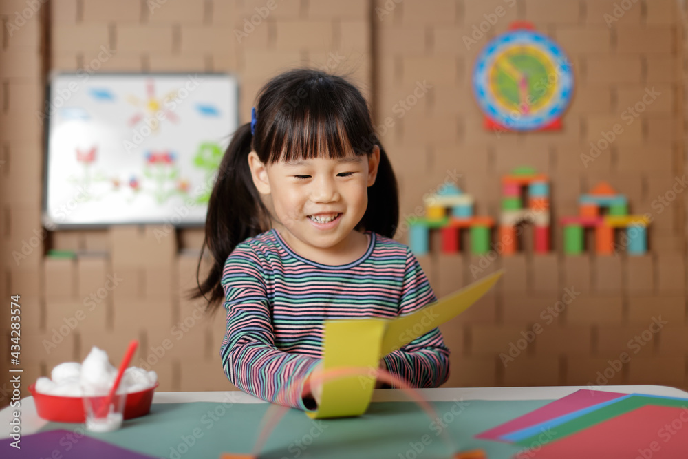young girl making paper craft for homeschooling Stock Photo | Adobe Stock