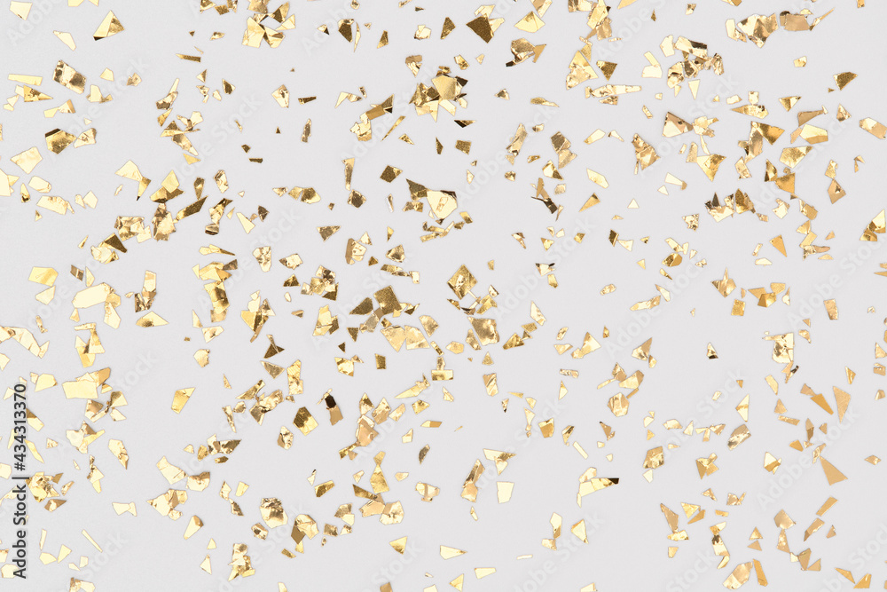 Gold confetti sparkles on white background, golden foil, festive ...