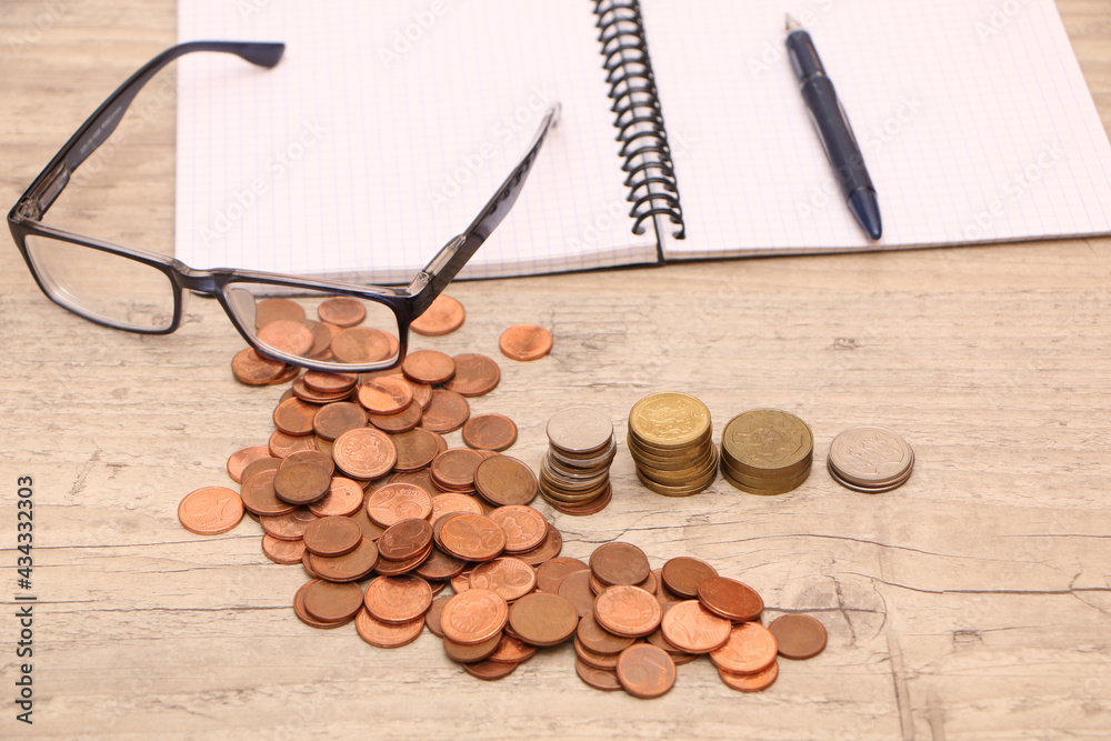 Money and a financial income chart are on the desk in the office. Stock ...