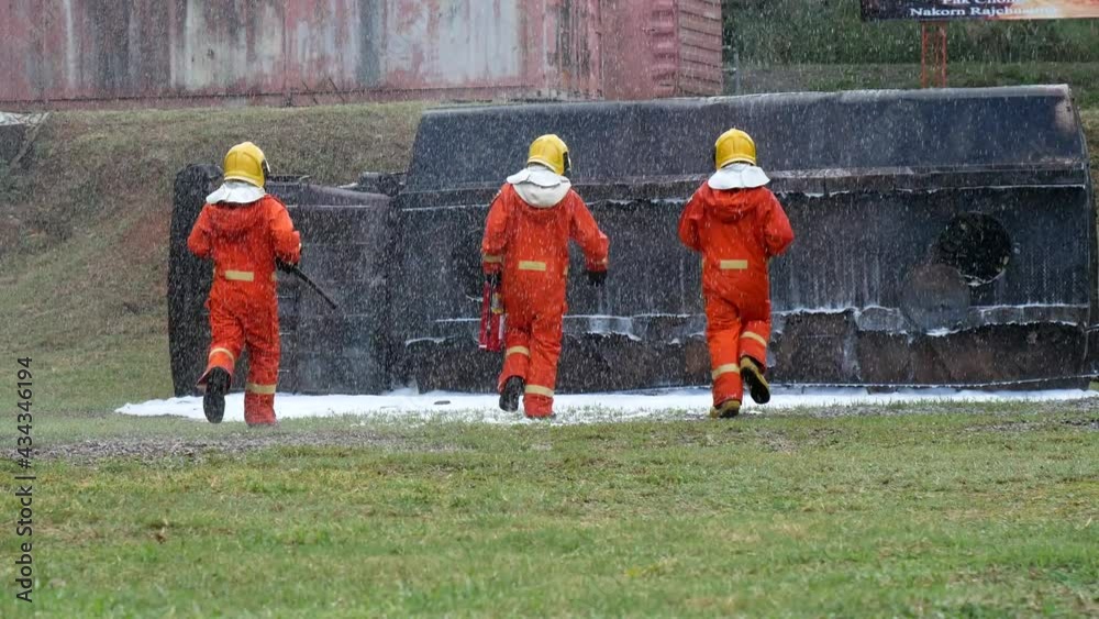 Firefighter fighting with flame using fire hose chemical water foam ...
