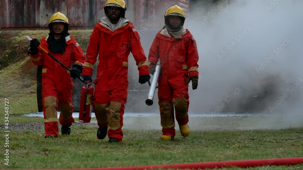 Firefighter fighting with flame using fire hose chemical water foam ...