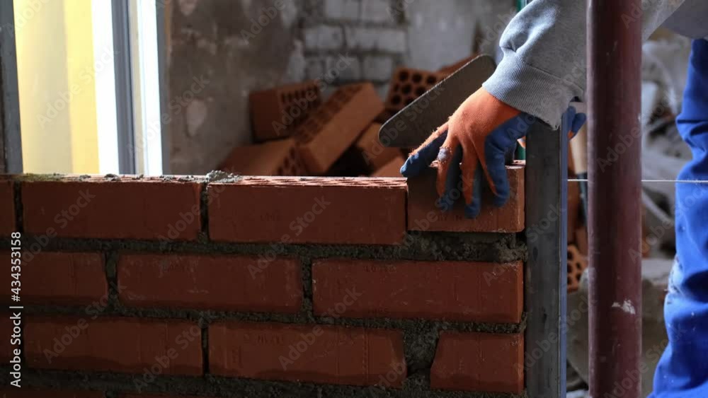 Construction worker building a brick wall. Man bricklaying. Mason ...