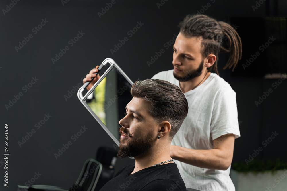 Barber with dreadlocks showing result of low fade machine hair and ...