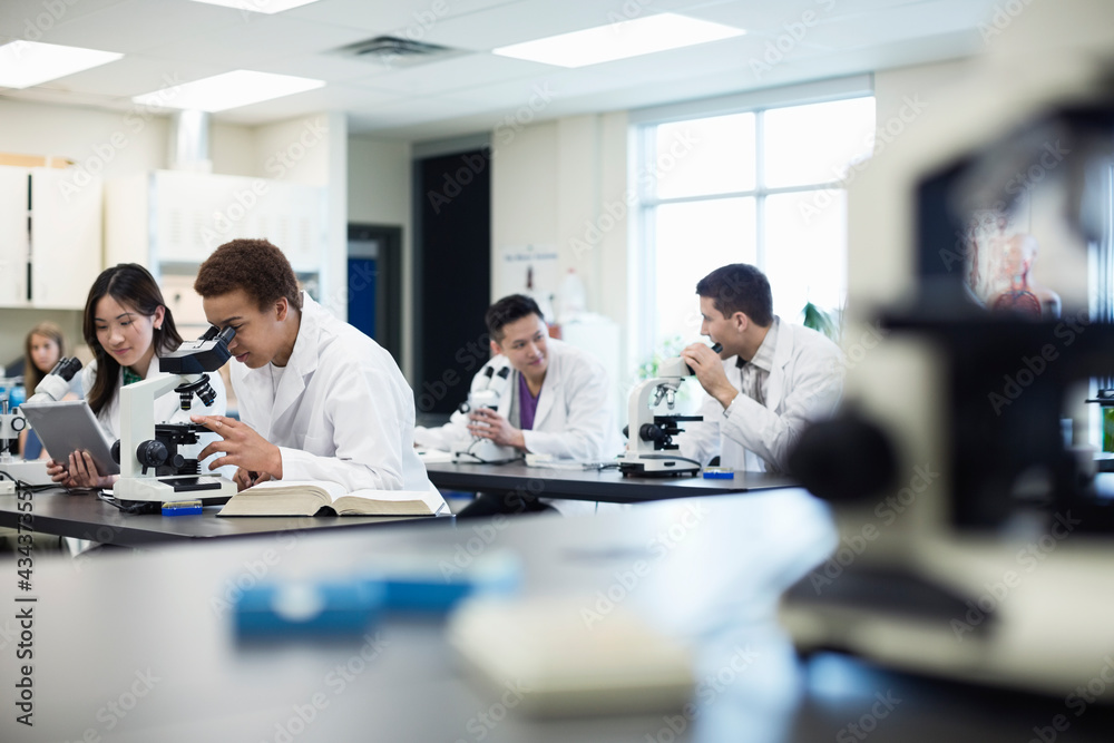 Students using microscopes in college science lab Stock Photo | Adobe Stock