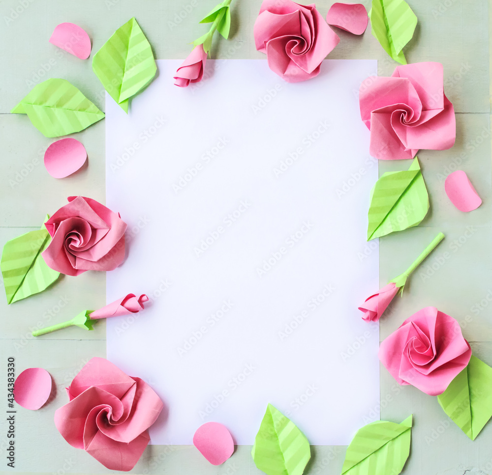 Origami paper background with flowers and leaves. Handmade pink roses ...