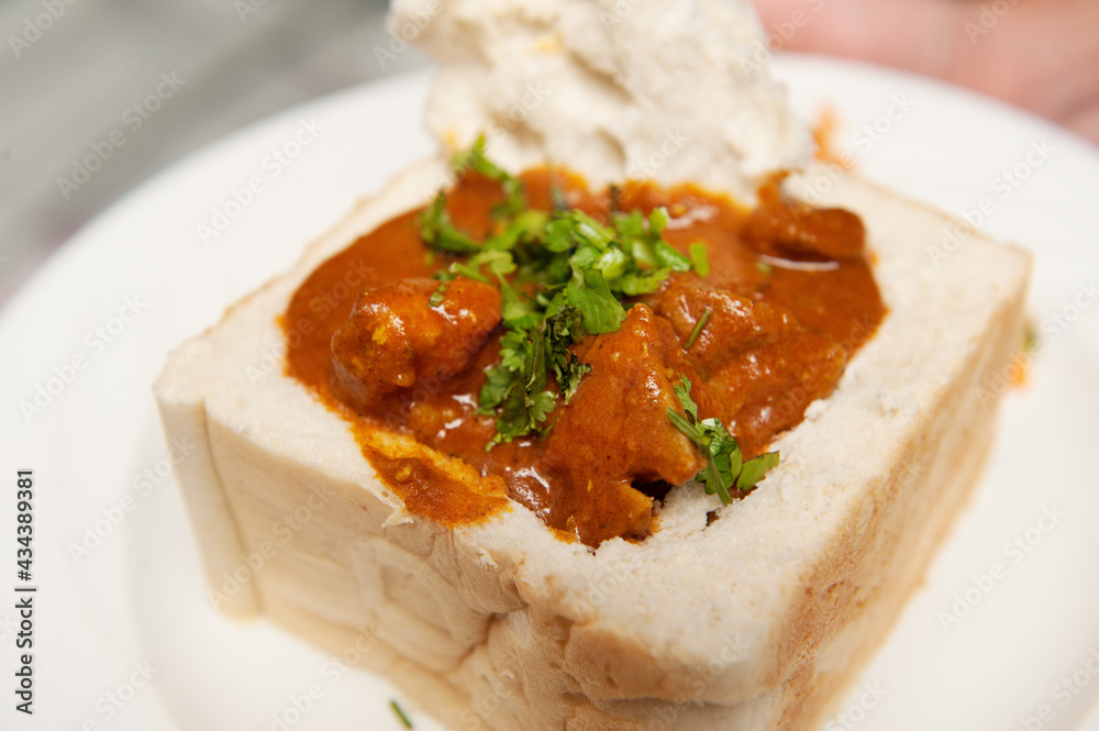 A traditional South African bunny chow, Indian curry served in a ...