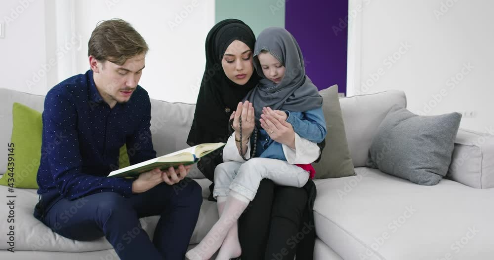 Traditional muslim family parents with children reading Quran and ...