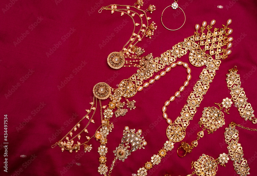 Indian traditional gold Indian wedding women's jewelry on red saree ...
