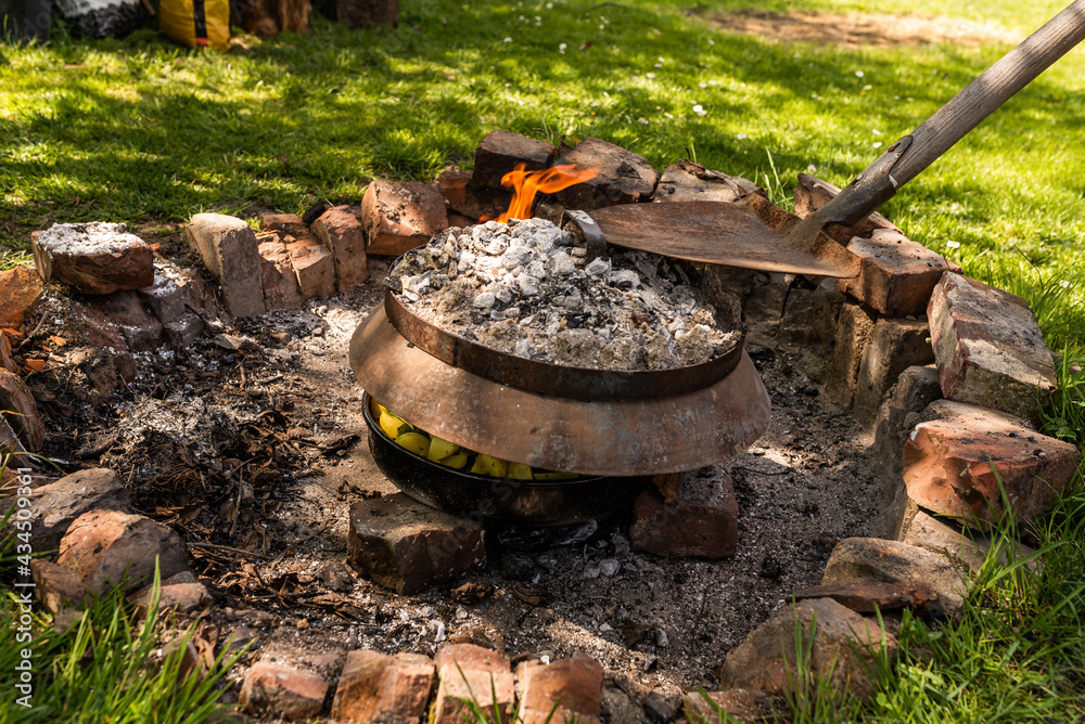 Cooking traditional dalmatian, croatian, bosnian dish called peka. Meat ...