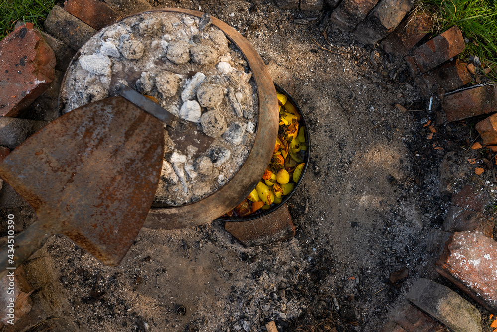 Cooking traditional dalmatian, croatian, bosnian dish called peka. Meat ...