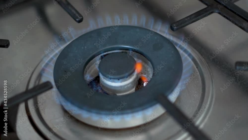 Lighting A Gas Stove Fire on the Kitchen Stove. The Burning Blue Flame ...