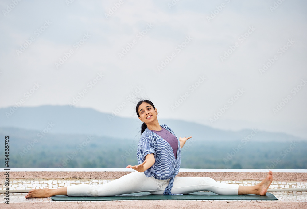 Young, sporty girl sitting on the splits outdoors in the forest. Yoga ...