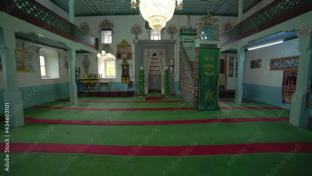 Muslim mosque teacher is reading the quran in in small historic wooden ...