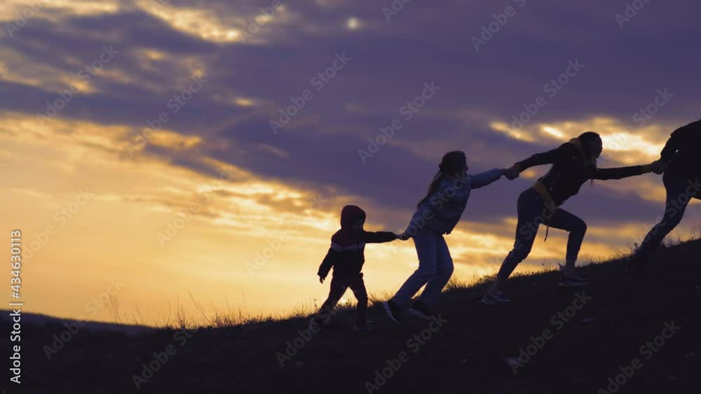 Giving a helping hand. Silhouette of family helping each other on top ...
