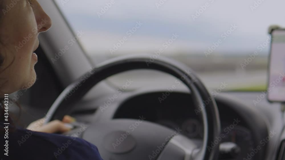 Video, woman hands drive a car, fingers lie on the steering wheel ...