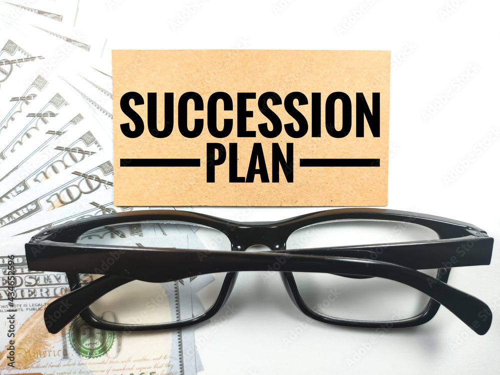 Business concept.Text SUCCESSION PLAN with glasses and banknote on ...