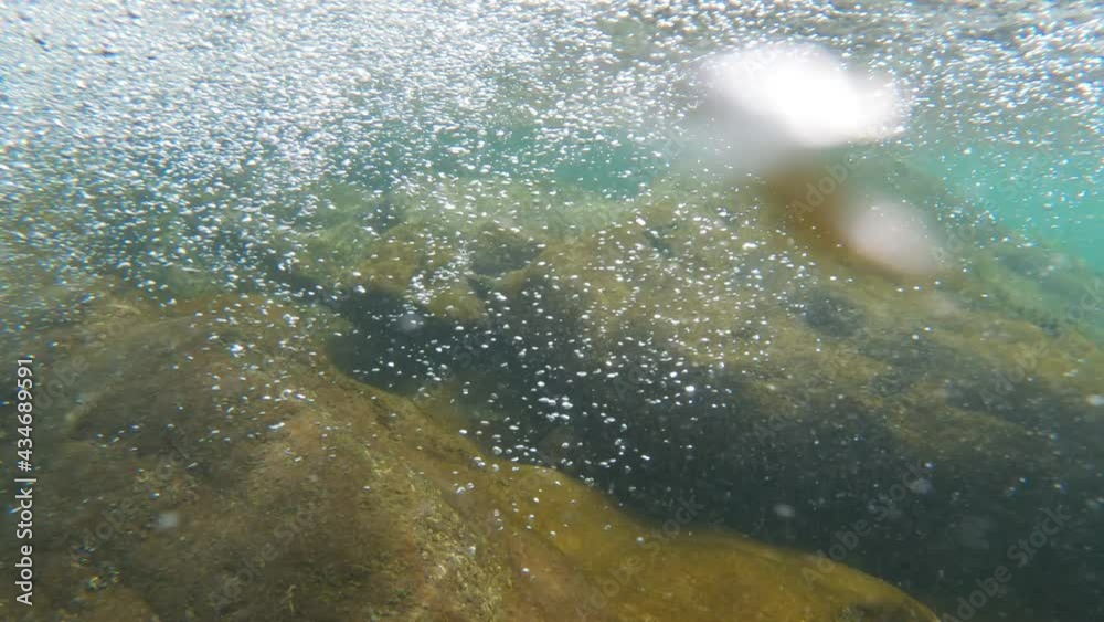 Water churned boils and bubbles underwater of fast flowing waters of ...