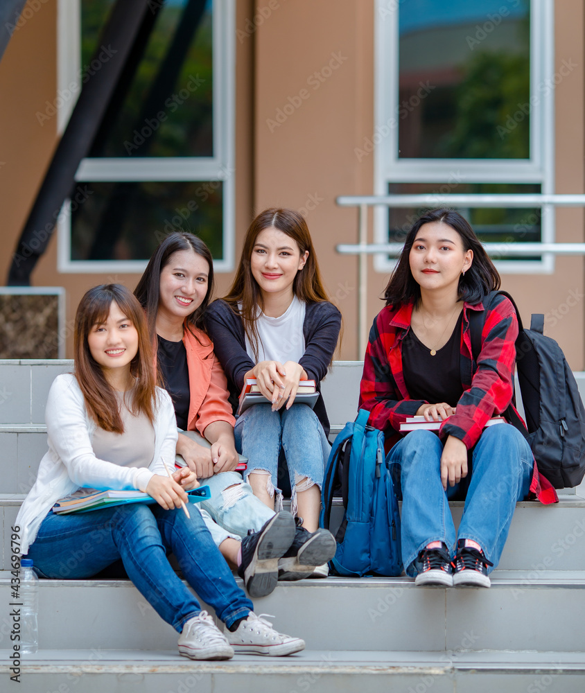 Students sitting on stairs and doing homework together Stock Photo ...