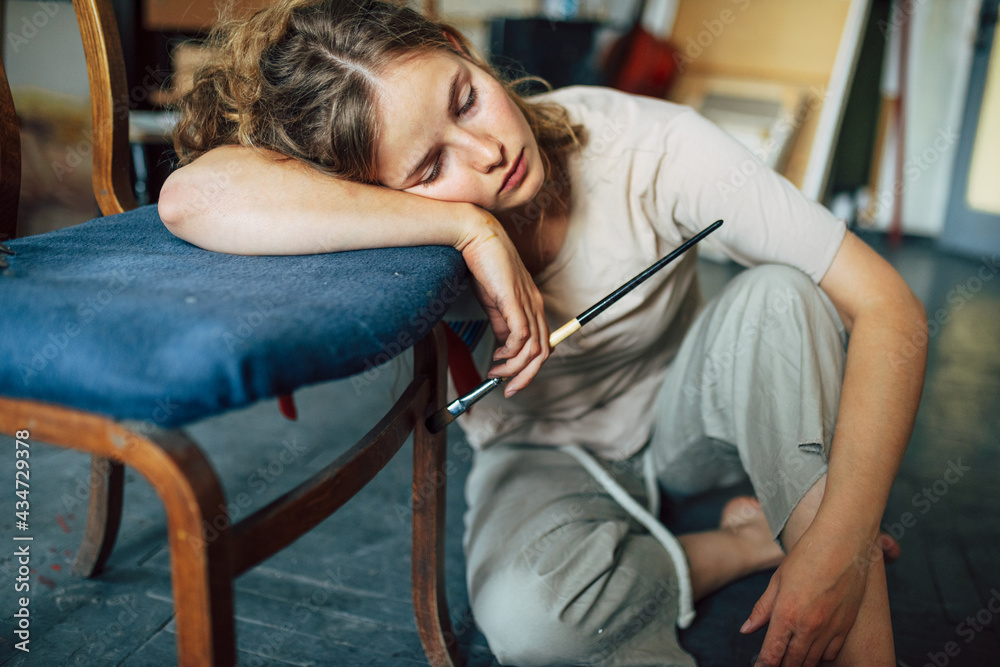 Photo Horizontal image of an overworked female artist resting in her ...