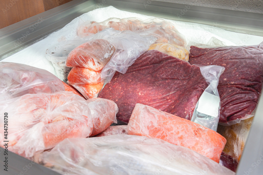 Frozen food in the freezer. Bagged frozen meat and other foods in a ...