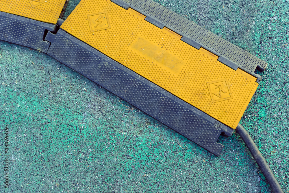 Black and yellow heavy plastic covers for people and vehicle to cross ...