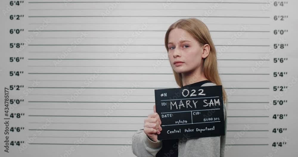 Side profile mugshot of female person with blond hair turning head and ...