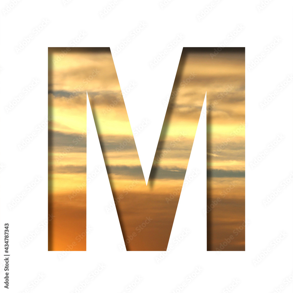 Font on the sunset sky. The letter M cut out of paper on the background ...