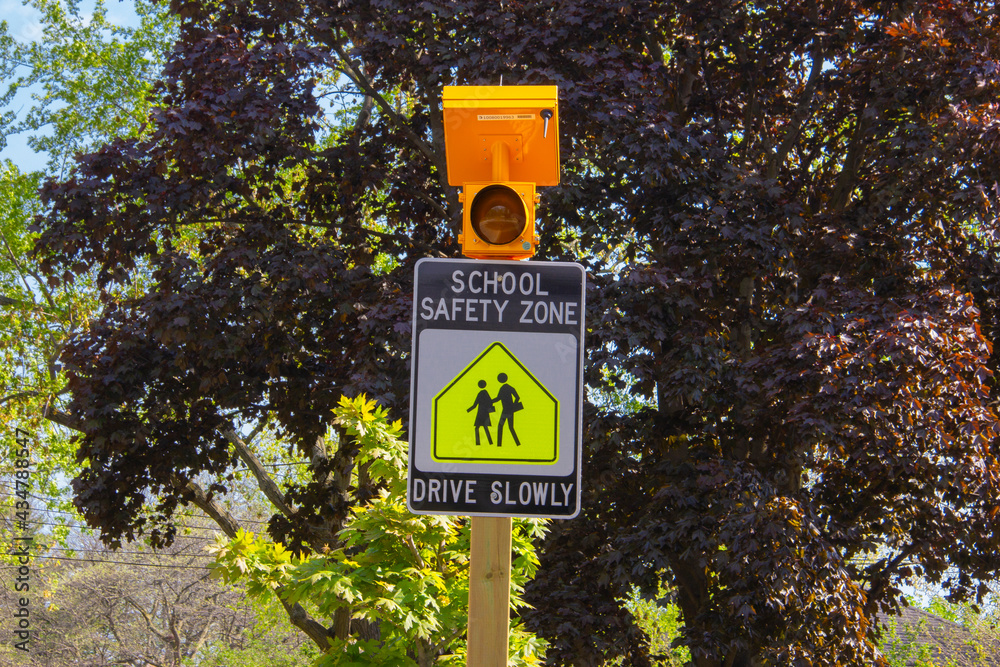 Blinking school safety zone sign Stock Photo | Adobe Stock