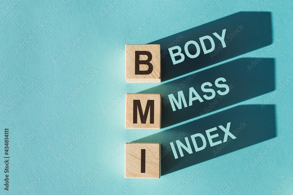 Wooden cubes building word BMI- (abbreviation Body Mass Index) on light ...