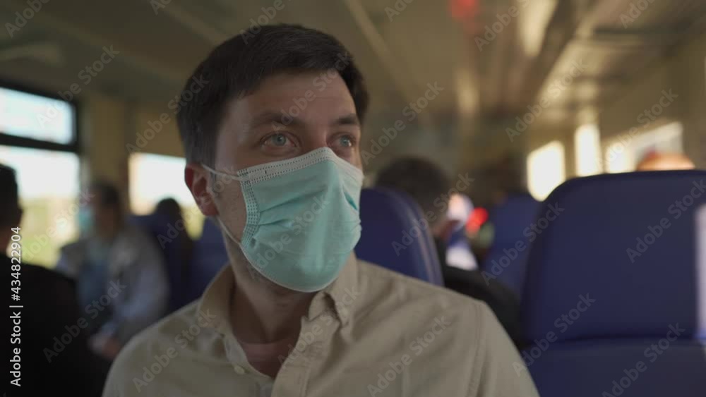 Video „Man traveling by train wearing a facemask. Social distancing ...