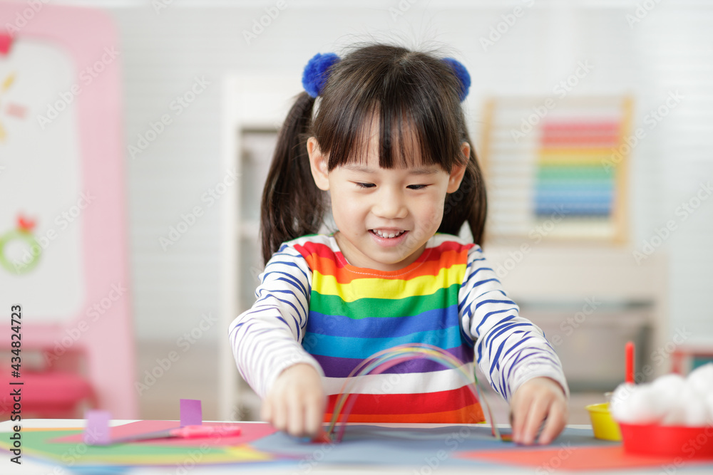 young girl making paper rainbow craft for homeschooling Stock Photo ...