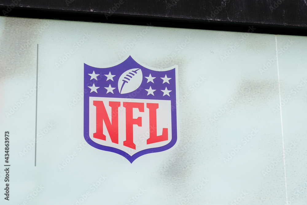 NFL logo sign and brand text on windows of sporty store of american ...