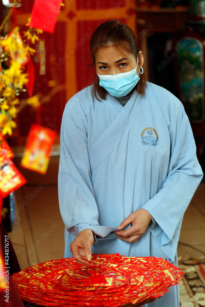 Tu An pagoda. Buddhist woman with red envelopes ( hongbao ) on yellow ...