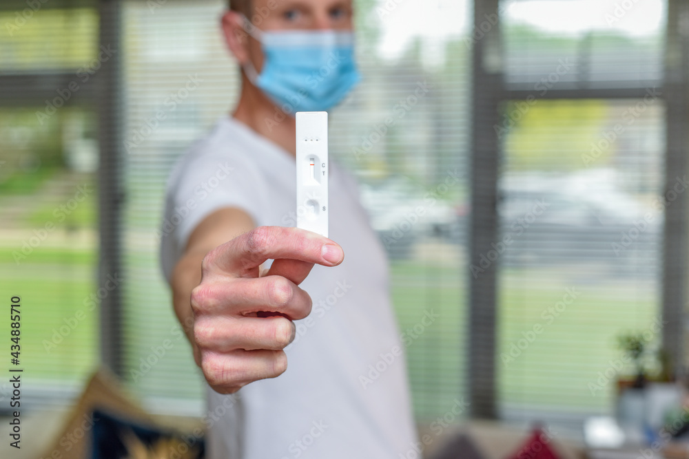 Man showing negative test for Covid-19 from a lateral flow coronavirus ...