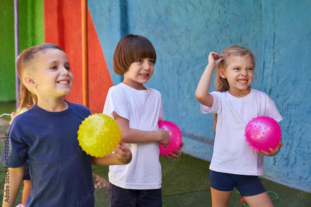 Group of kids has fun playing ball in school Stock Photo | Adobe Stock