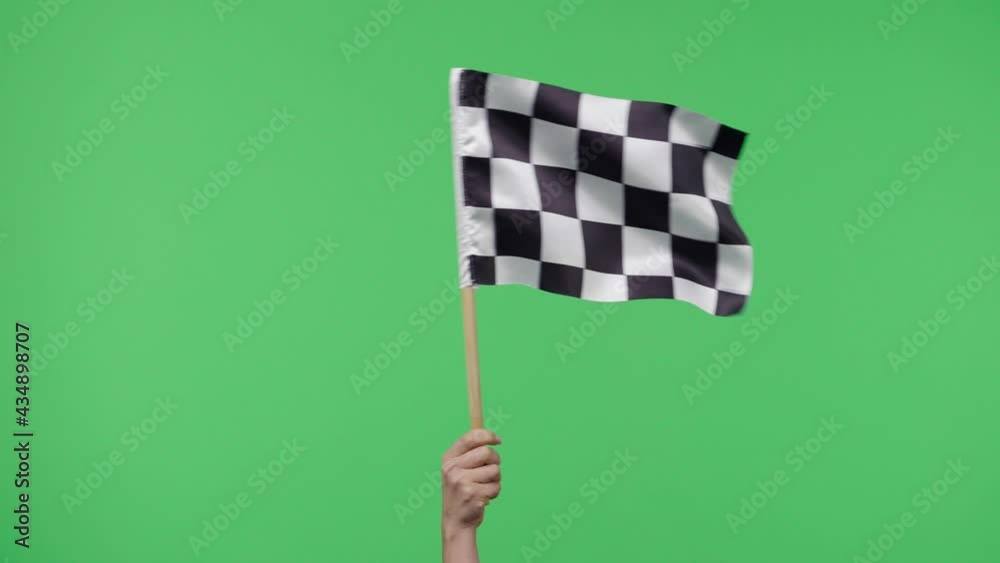 Female hand holding and waving checkered race flag in slow motion ...