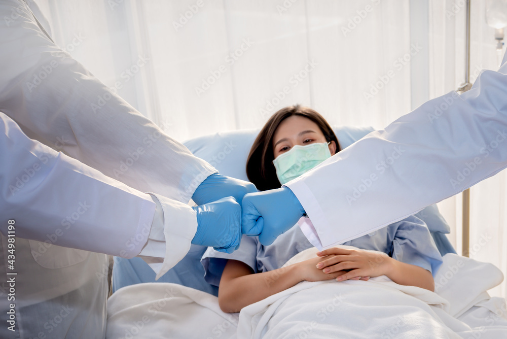 The teamwork of doctors are using hand for fist bump to show synergy ...