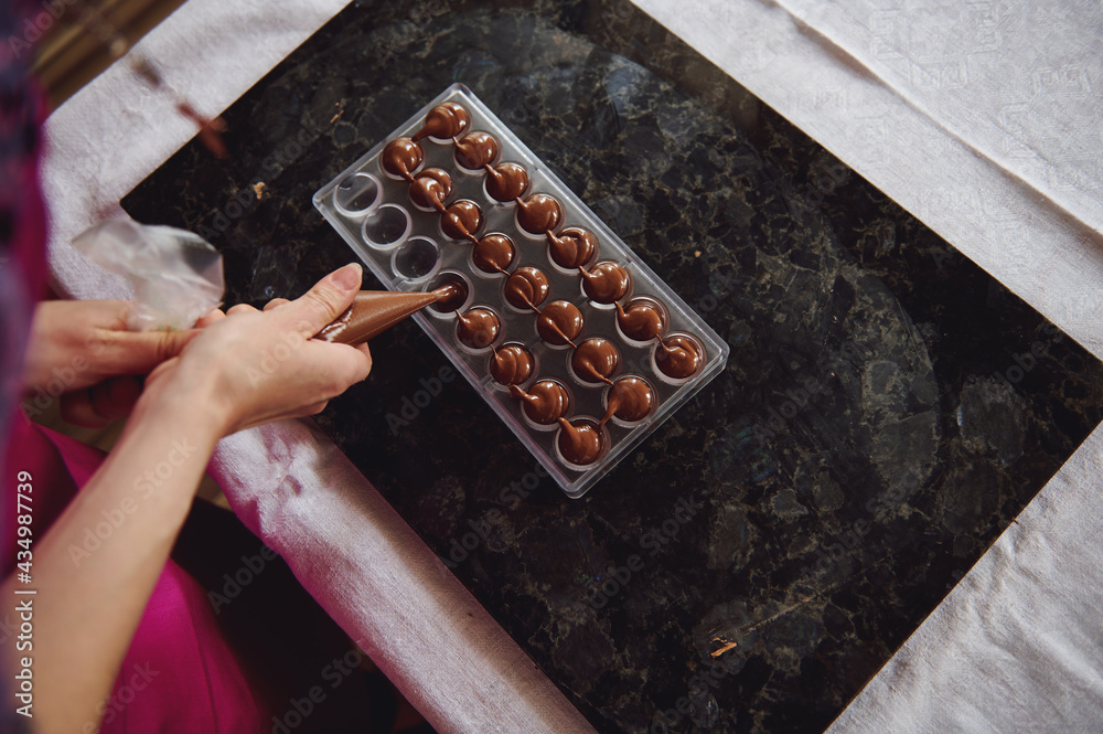 Process making handmade luxurious chocolates. Top view of a chocolatier ...
